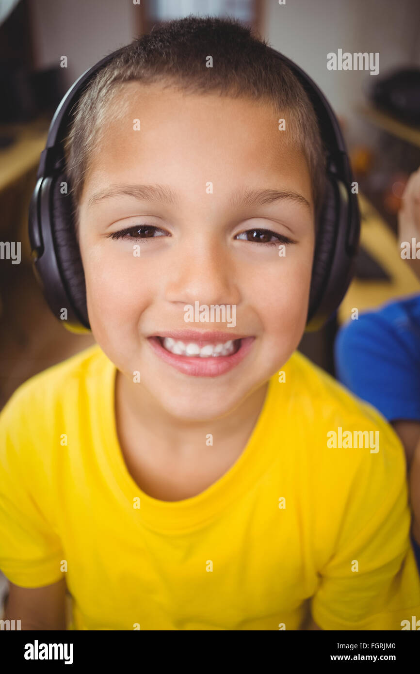 Cute pupil in computer class smiling at camera Stock Photo - Alamy