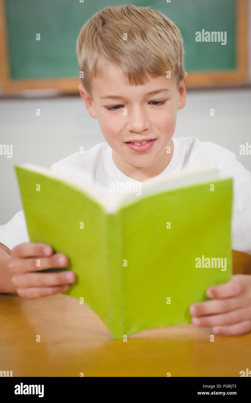 Happy student reading a book Stock Photo - Alamy