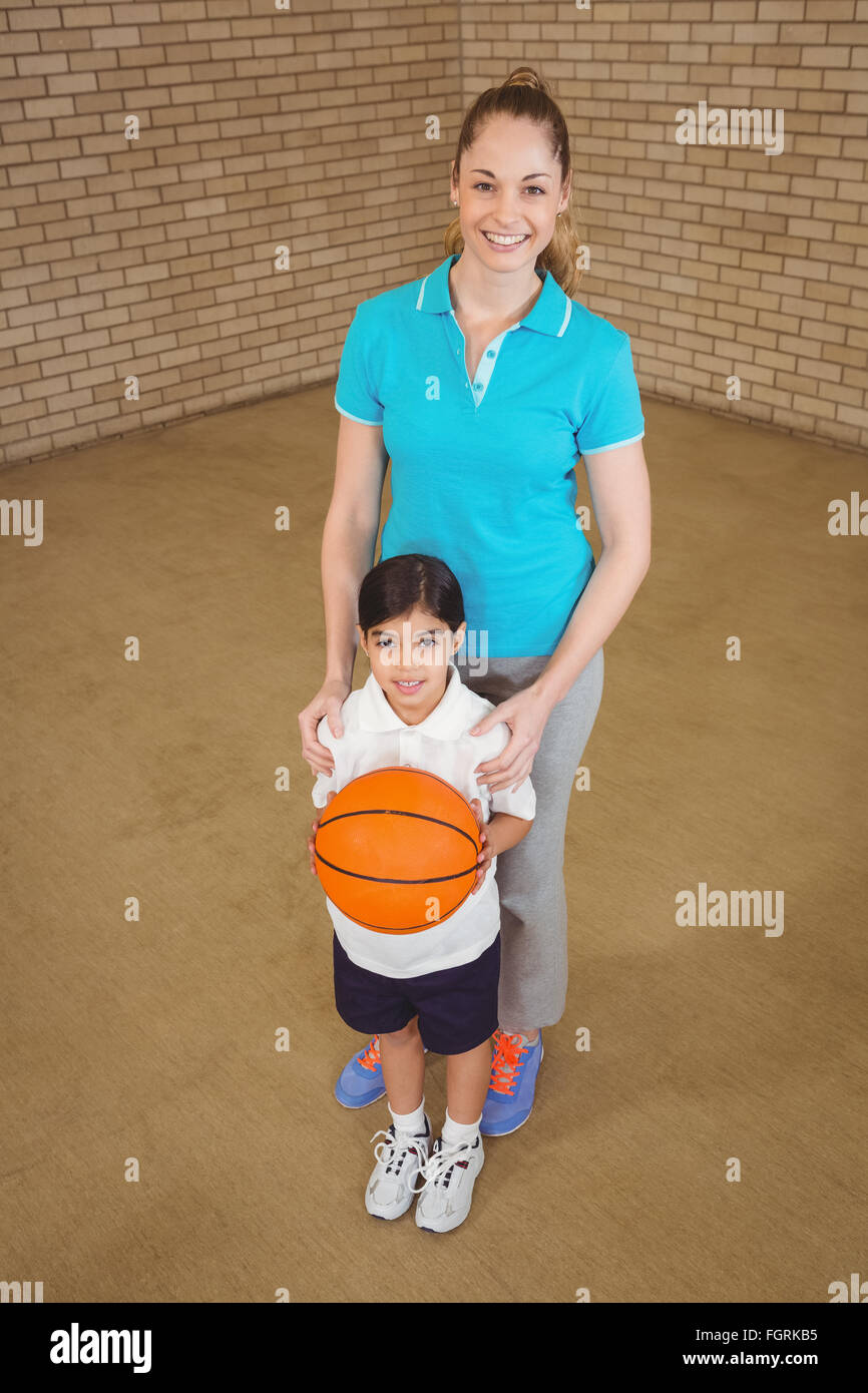 Student holding basketball with teacher Stock Photo - Alamy