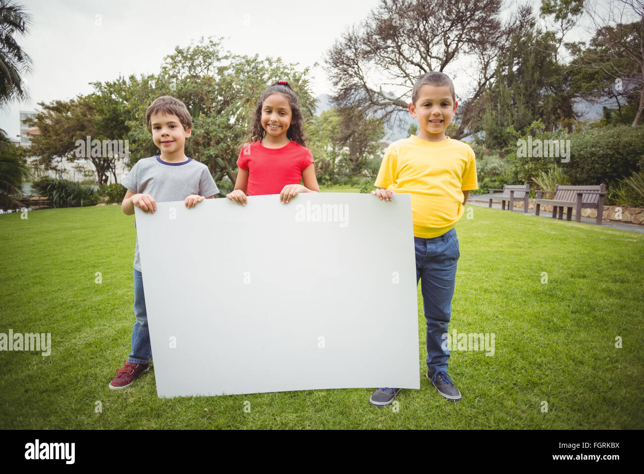 Cute pupils showing large poster Stock Photo - Alamy