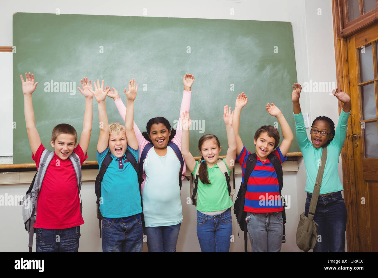 Students with arms raised together Stock Photo - Alamy