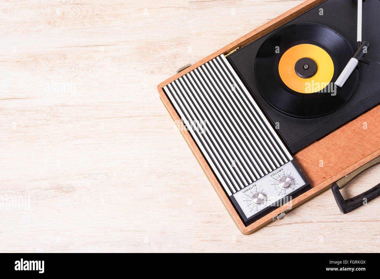 Gramophone with a vinyl record on wooden table, top view and copy space ...