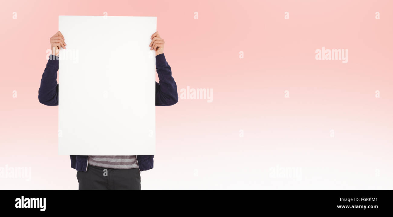 Composite image of man showing billboard in front of face Stock Photo ...