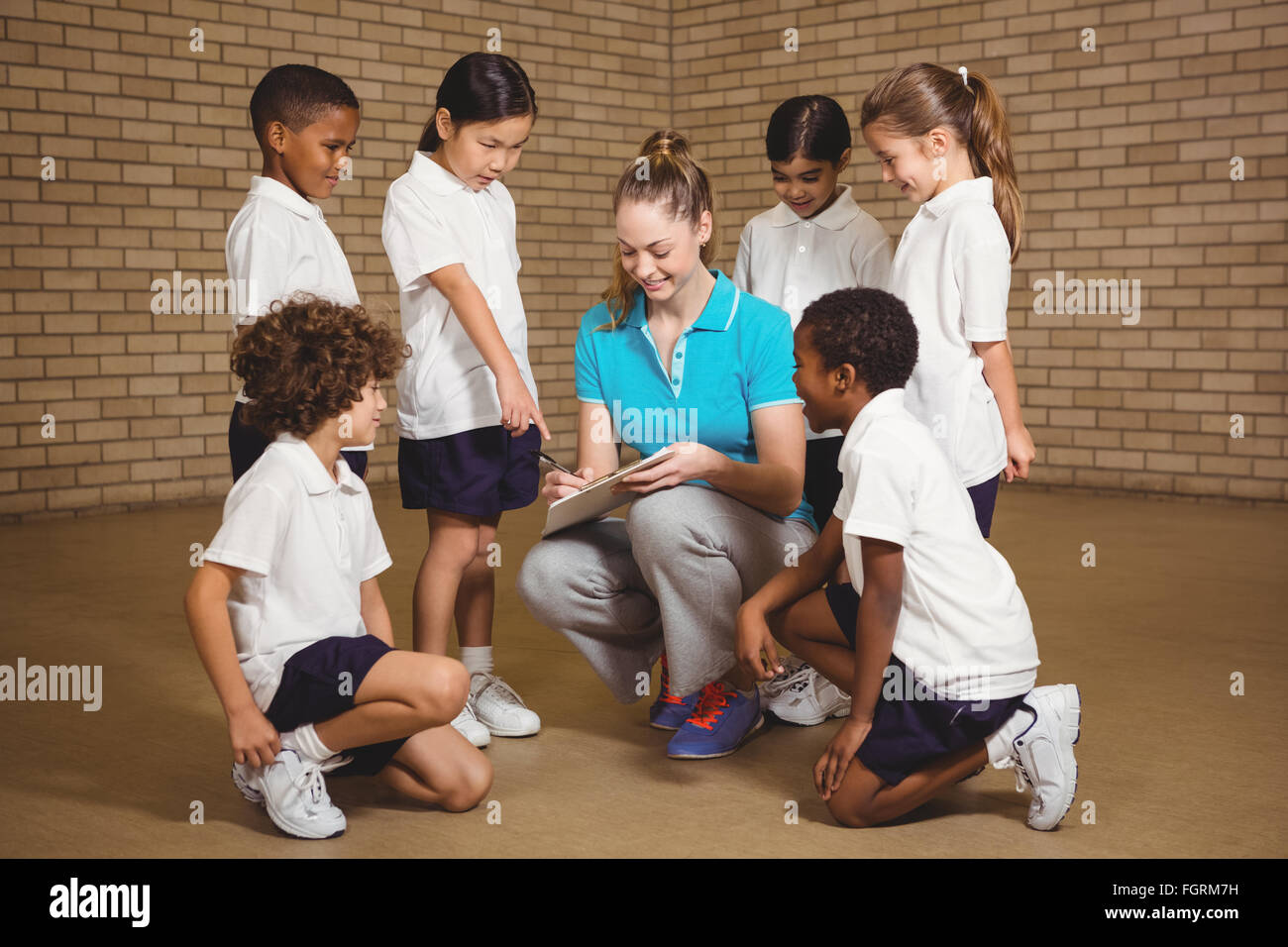 Sports students standing with the teacher Stock Photo - Alamy