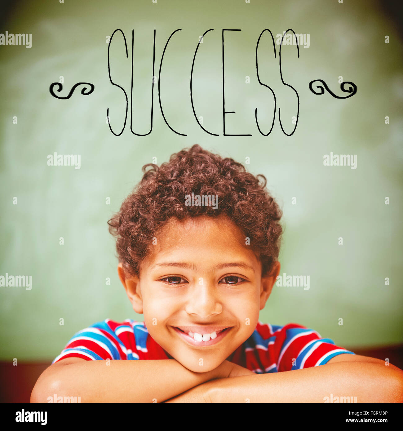 Success against little boy smiling in classroom Stock Photo - Alamy