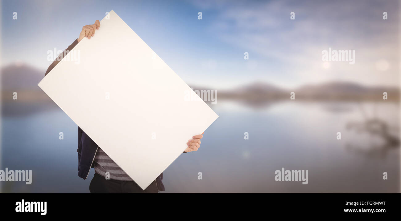 Composite image of man holding billboard in front of face Stock Photo ...
