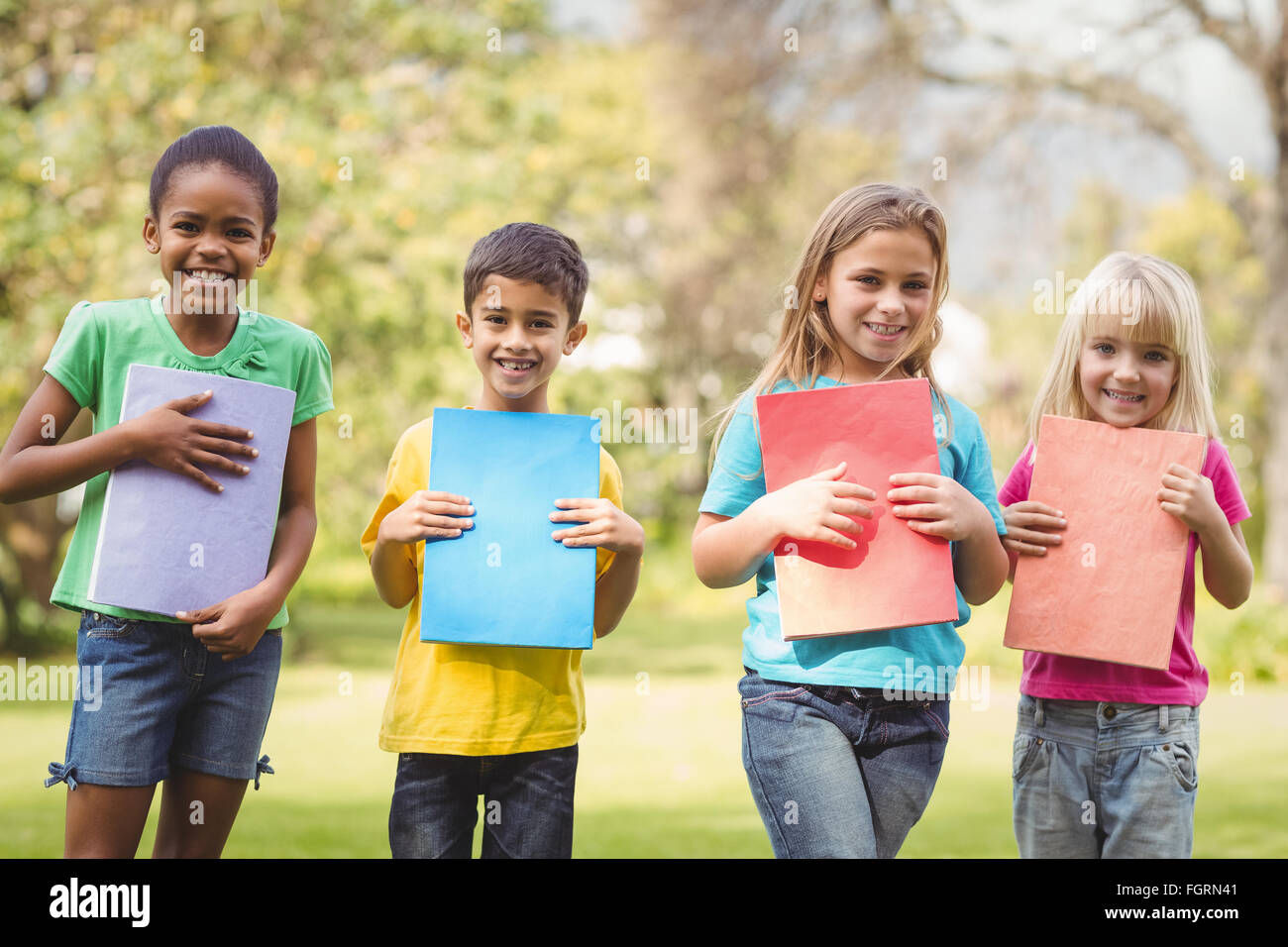Smiling classmates holding notepads Stock Photo - Alamy