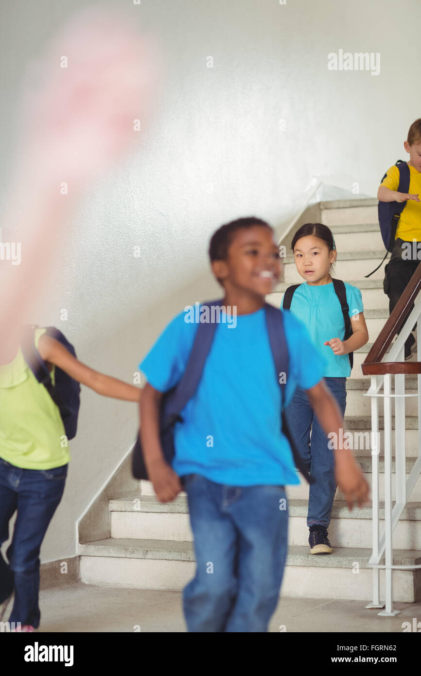 Happy pupils walking down the stairs Stock Photo - Alamy