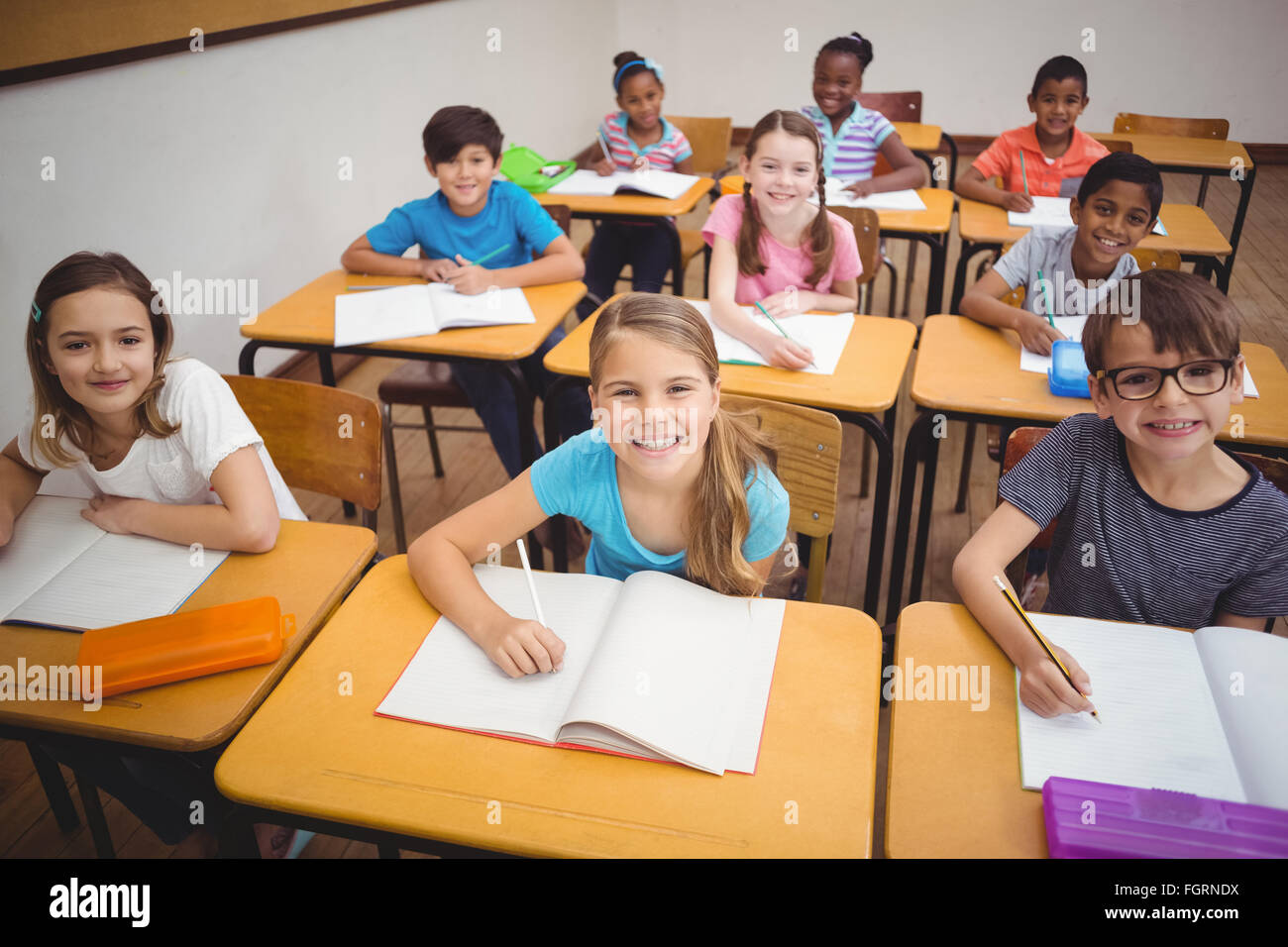 Happy pupils smiling at camera Stock Photo - Alamy