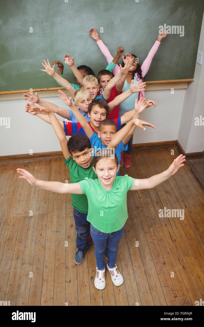 Students with arms raised together Stock Photo - Alamy