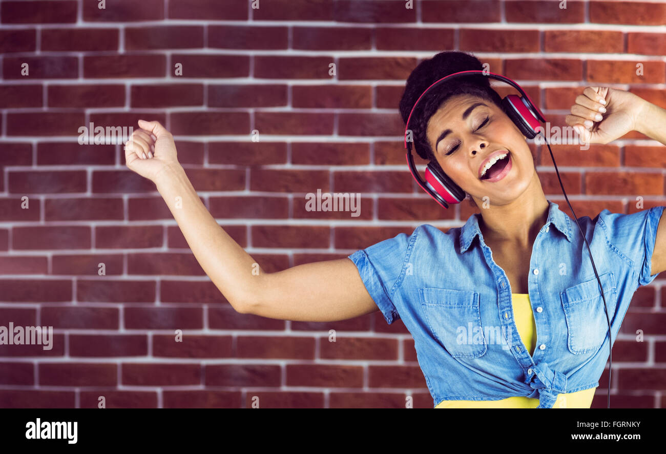 A smiling woman dancing with headphones Stock Photo - Alamy