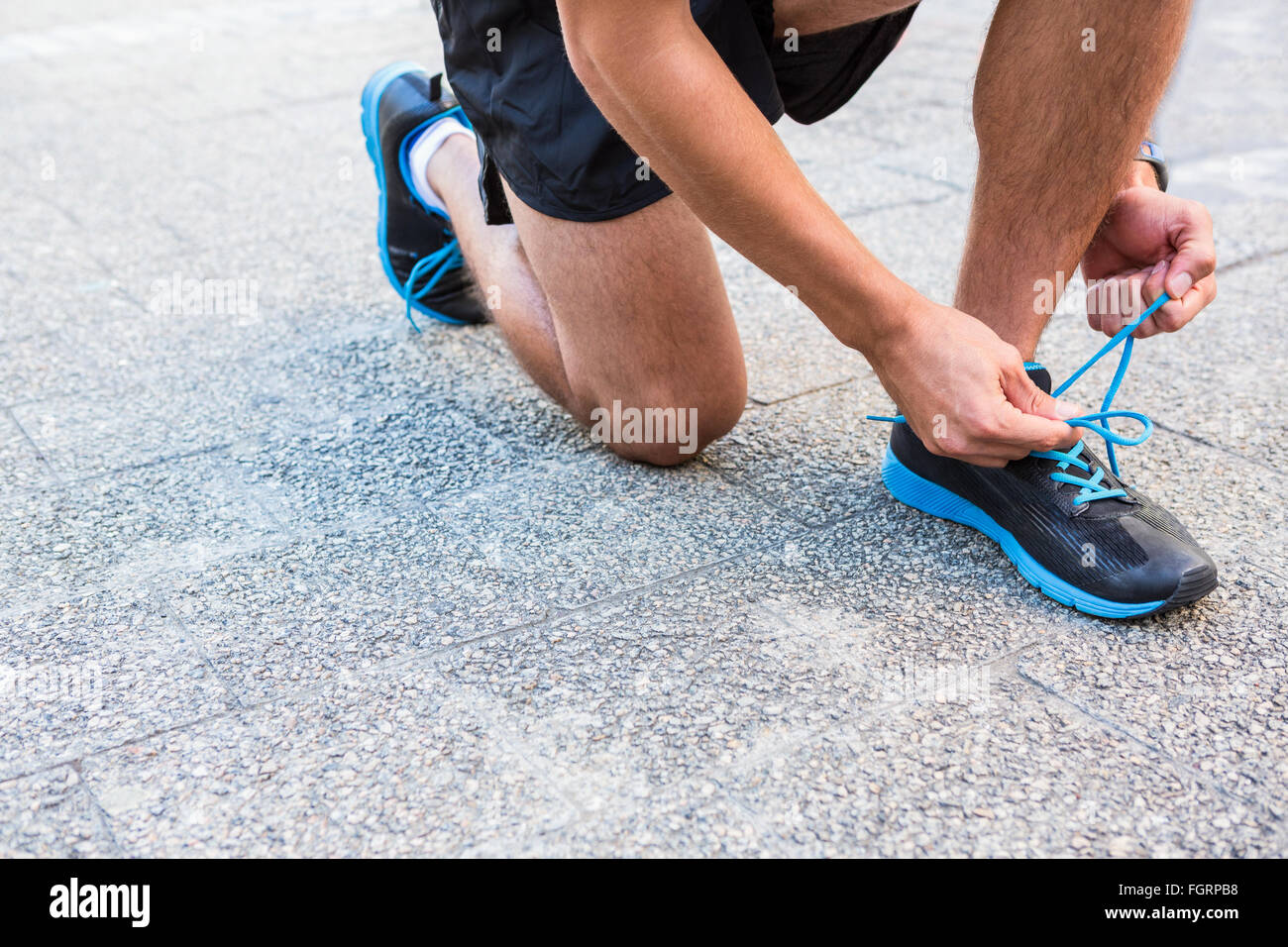 Athlete tying his shoes Stock Photo - Alamy
