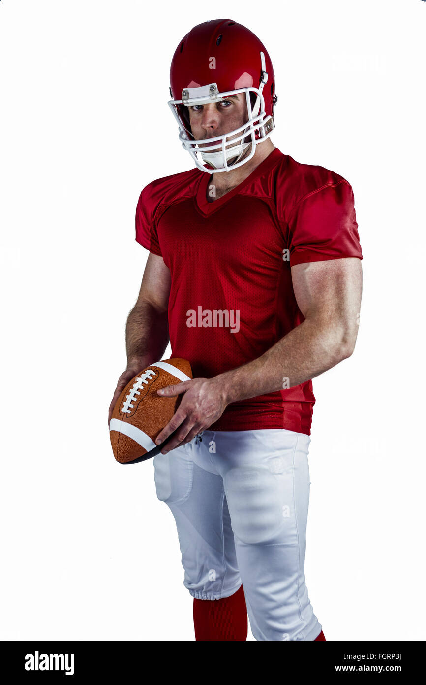 American football player holding ball Stock Photo - Alamy