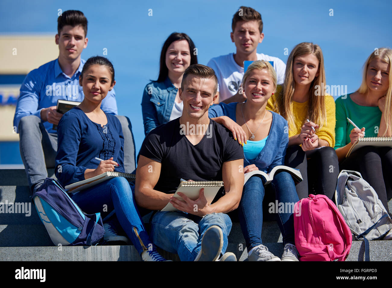 students outside sitting on steps Stock Photo - Alamy