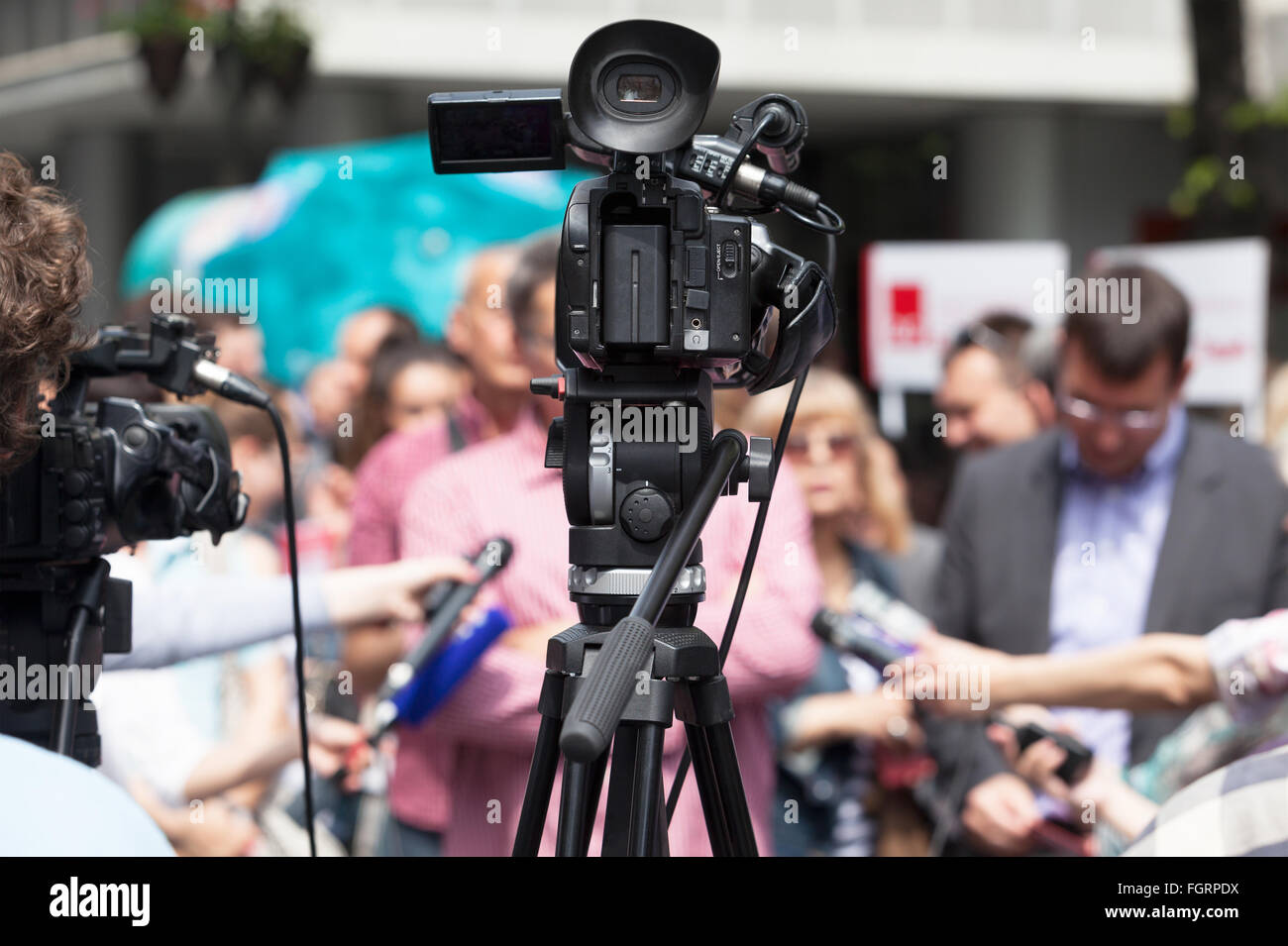 Filming an event with a video camera. Media interview Stock Photo - Alamy