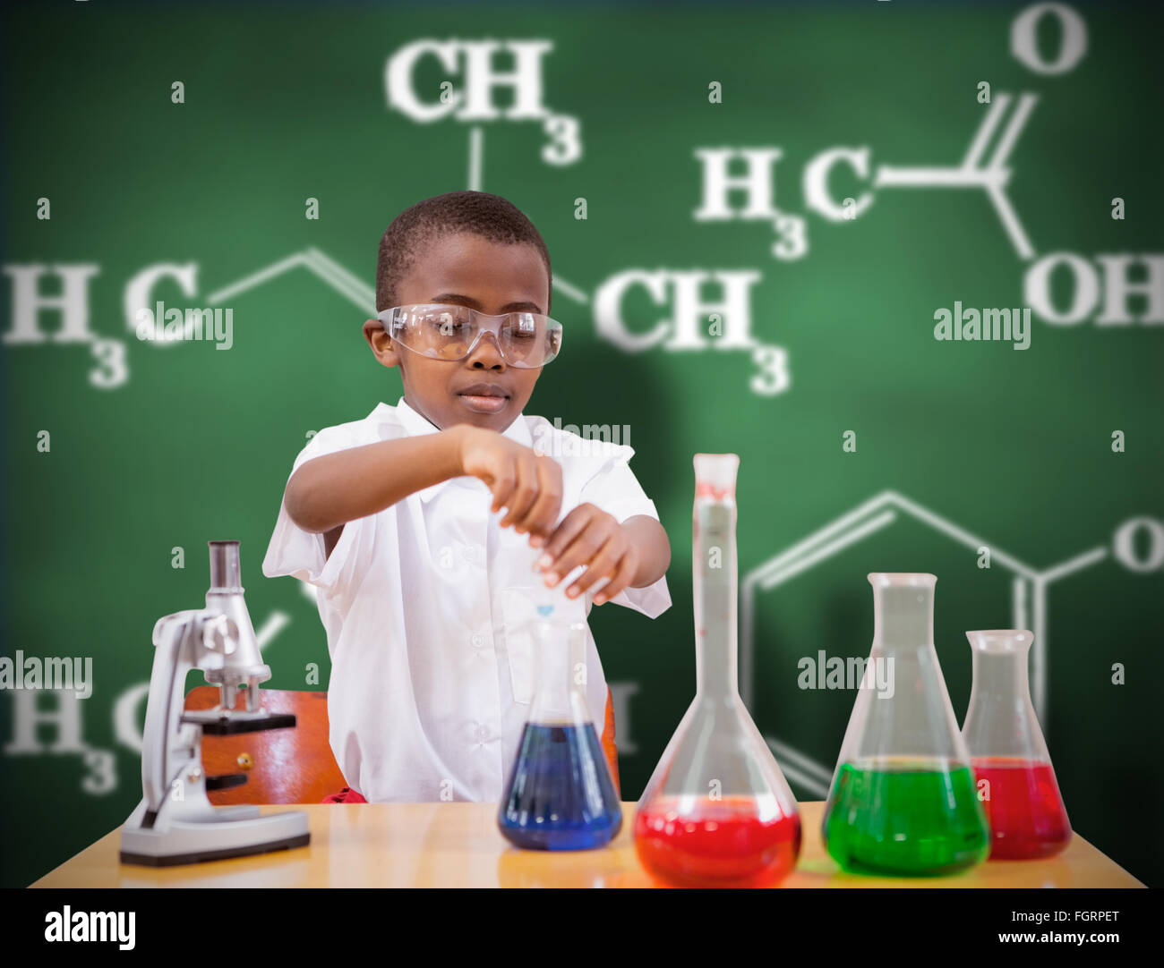 Composite image of cute pupil playing scientist Stock Photo - Alamy