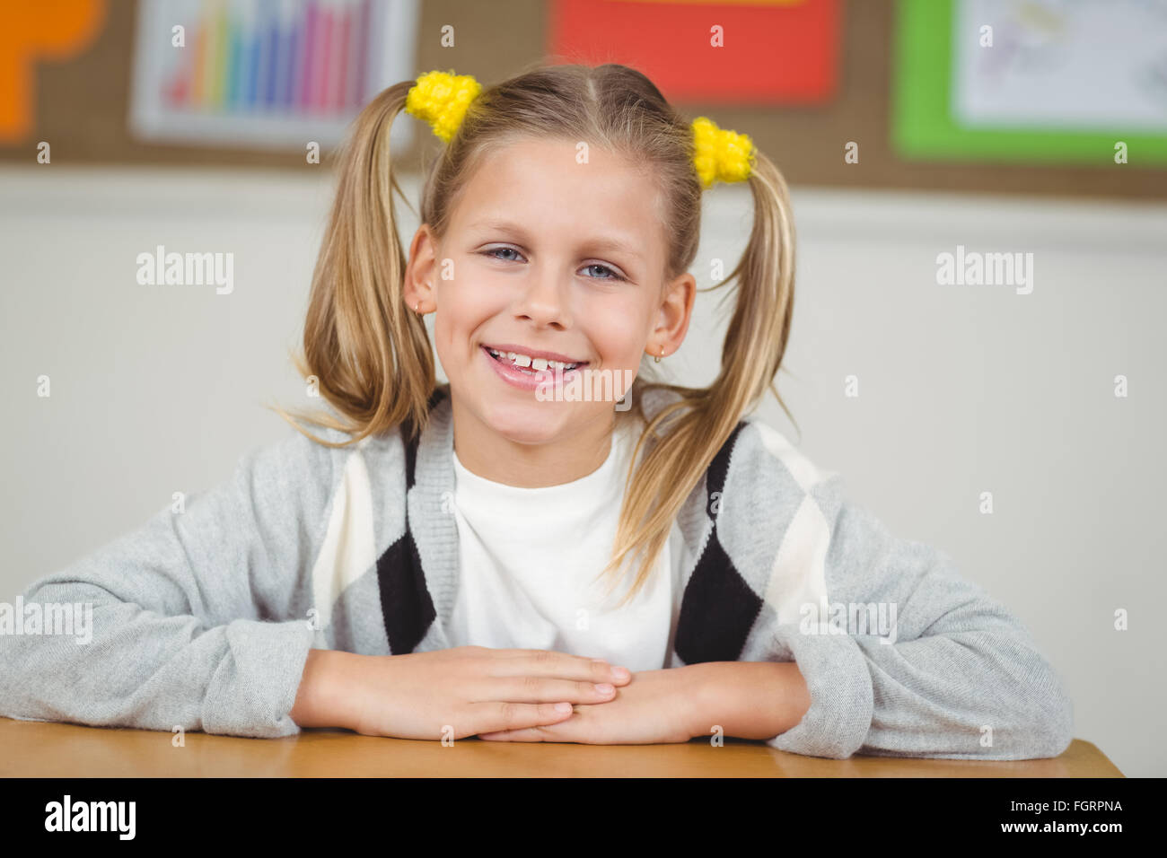 Cute pupil sitting at her desk in a classroom Stock Photo - Alamy