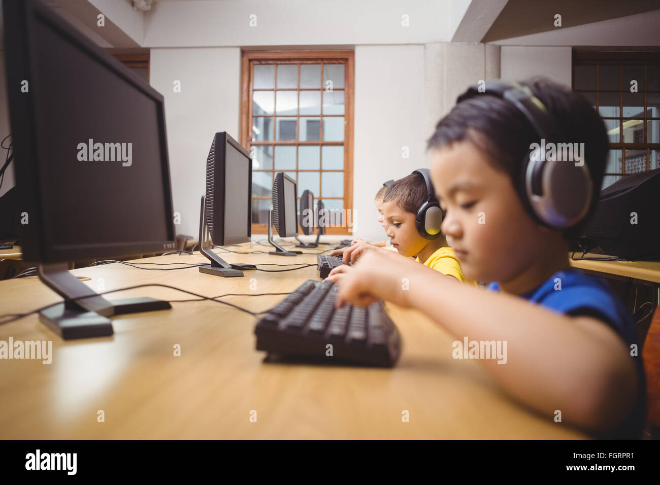 Cute pupils in computer class Stock Photo - Alamy