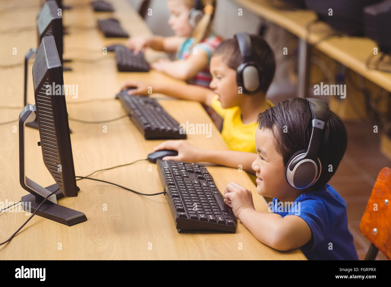 Cute pupils in computer class Stock Photo - Alamy