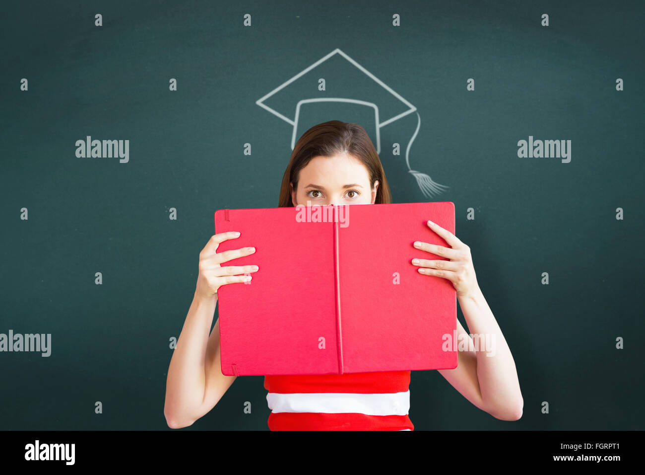 Composite image of student holding book over face Stock Photo - Alamy