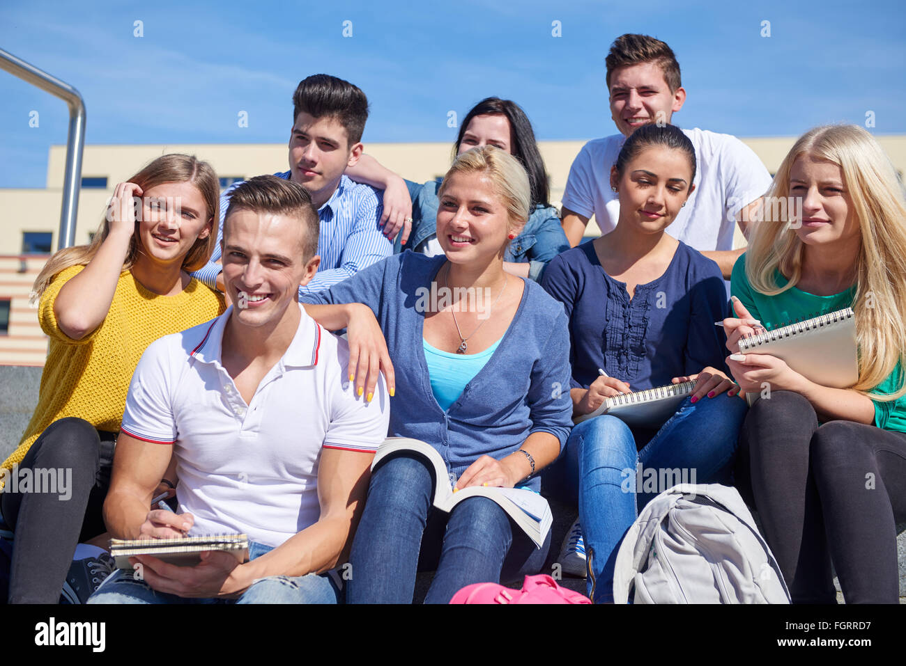 students outside sitting on steps Stock Photo - Alamy