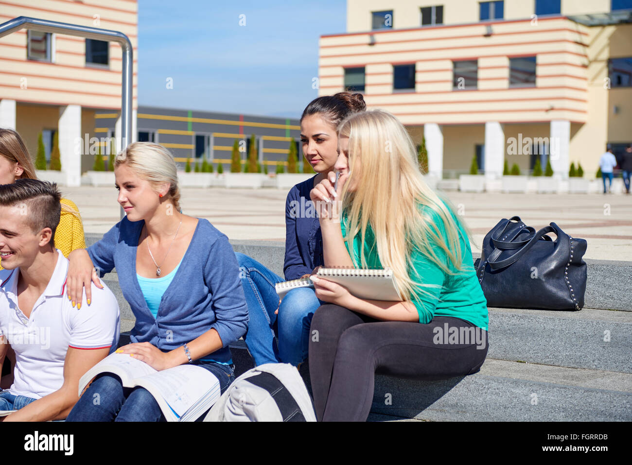 students outside sitting on steps Stock Photo - Alamy