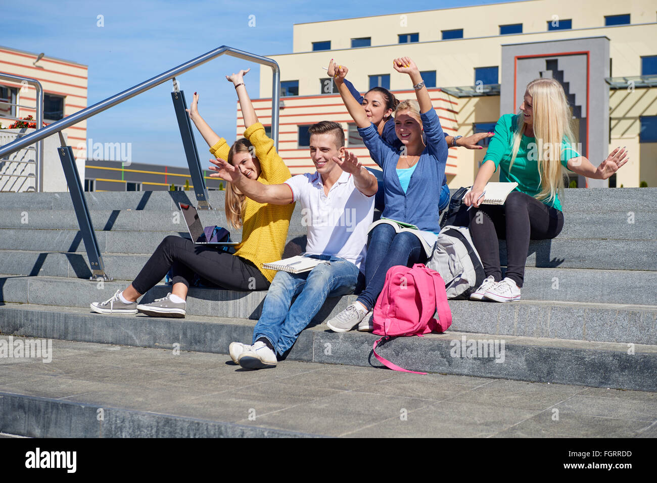students outside sitting on steps Stock Photo - Alamy