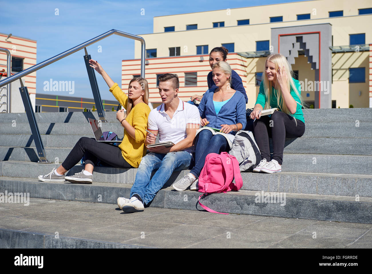 students outside sitting on steps Stock Photo - Alamy