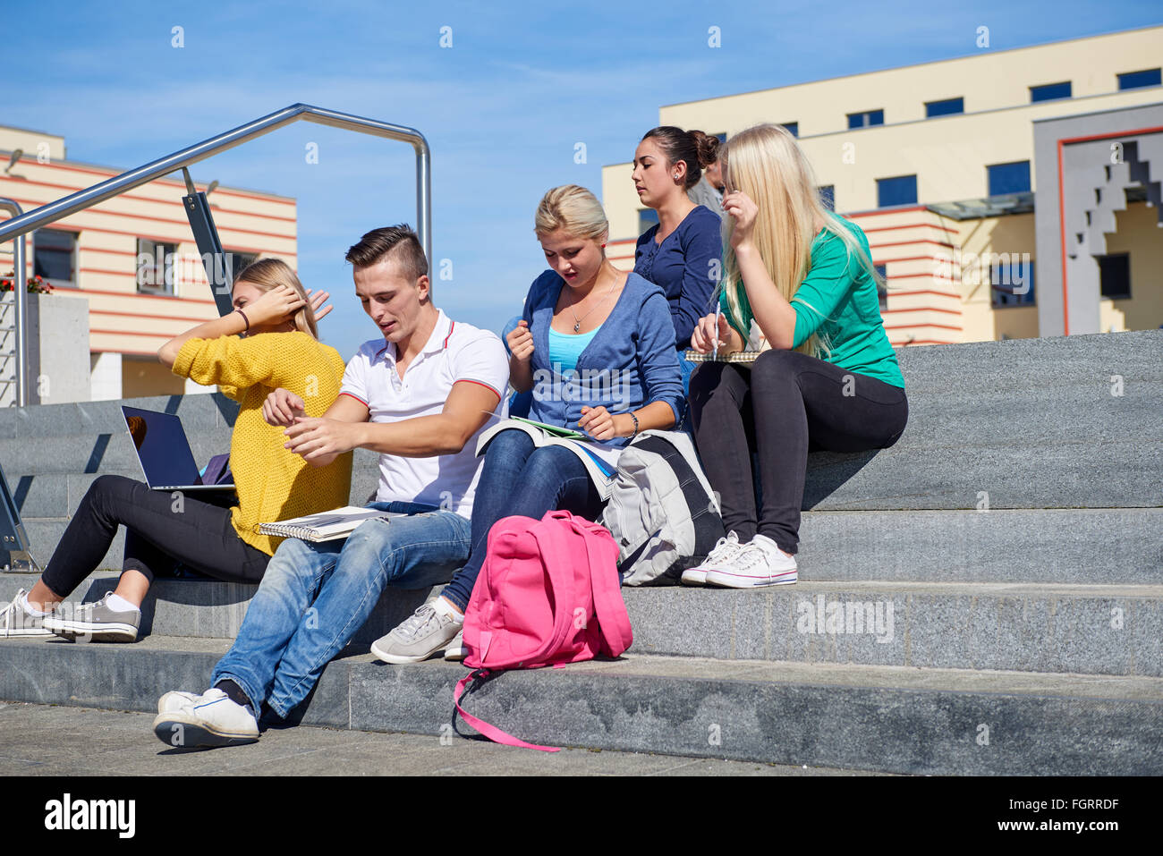 students outside sitting on steps Stock Photo - Alamy