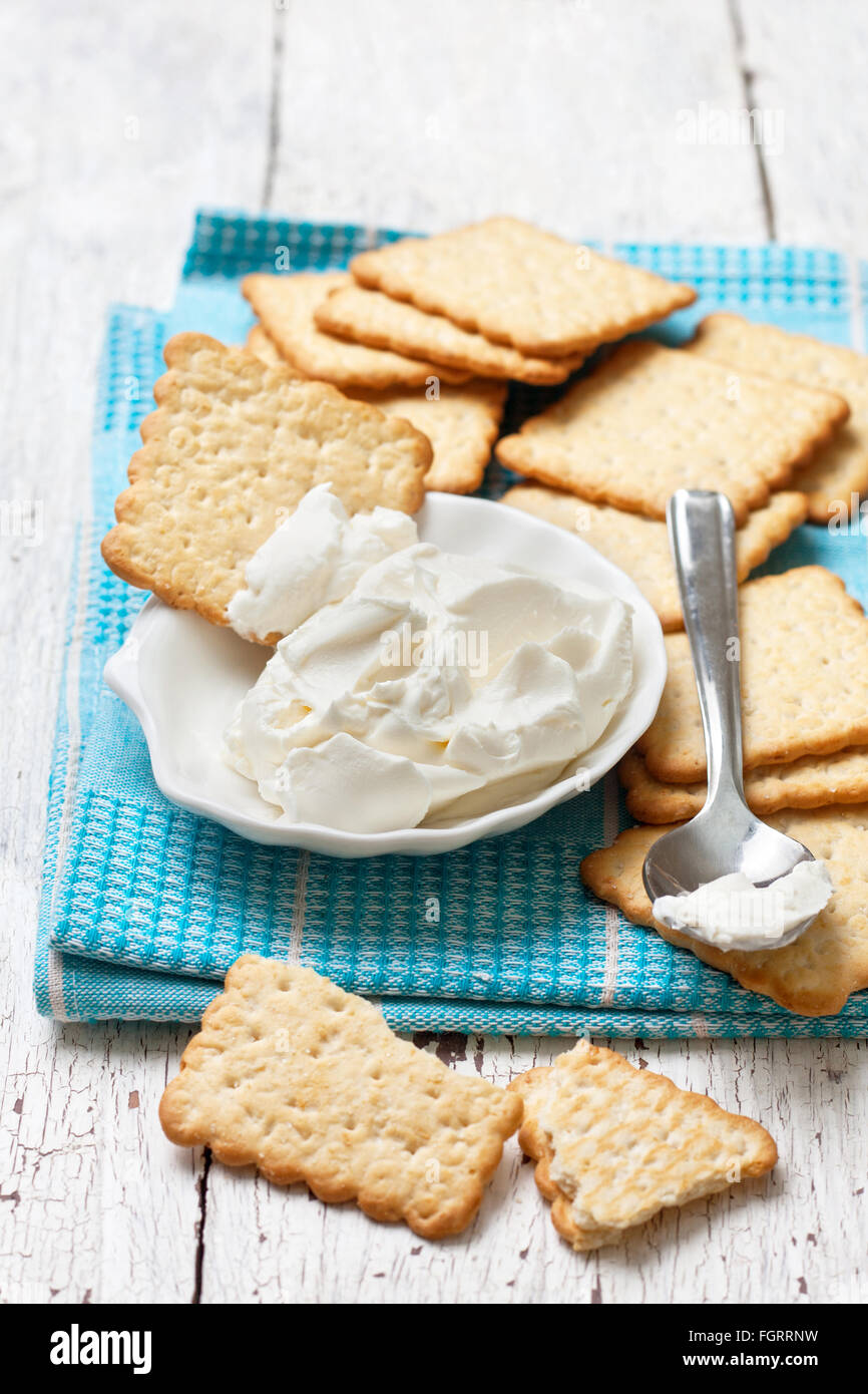 light snack of crackers and cream cheese on blue napkin Stock Photo - Alamy