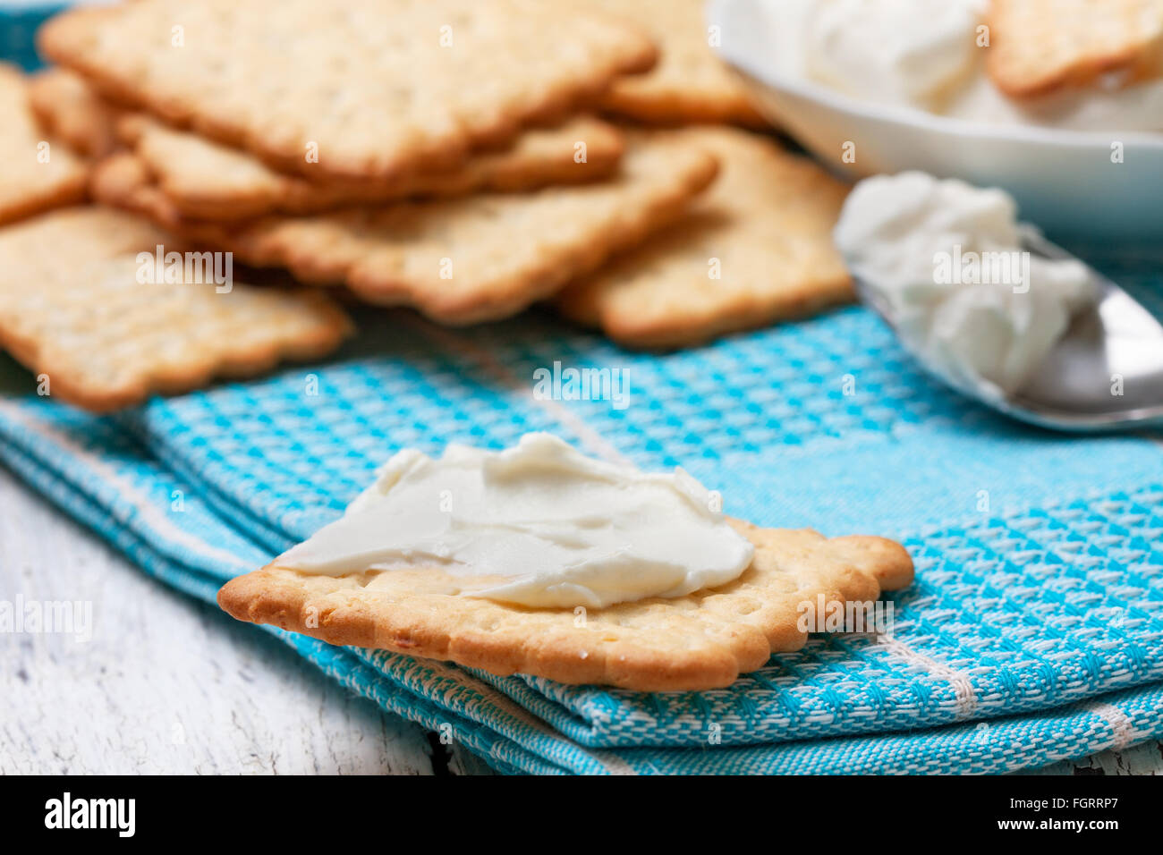 light snack of crackers and cream cheese on blue napkin Stock Photo - Alamy