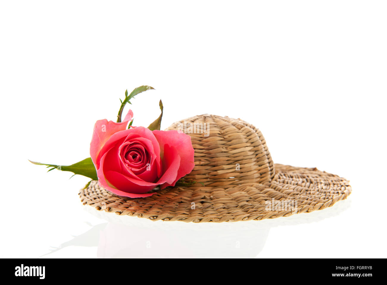 Wicker summer hat with pink rose isolated over white background Stock ...