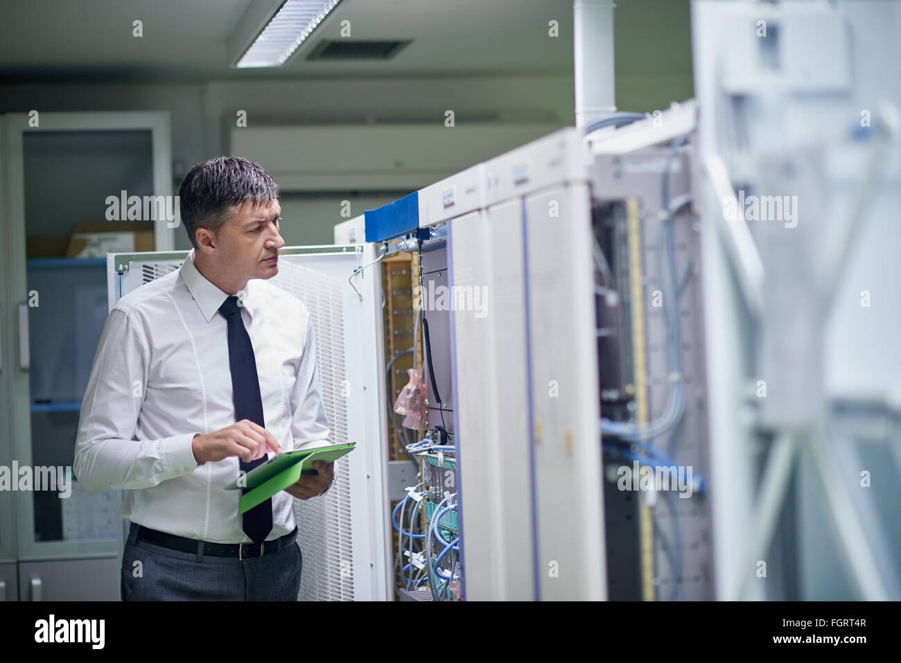 network engineer working in server room Stock Photo - Alamy