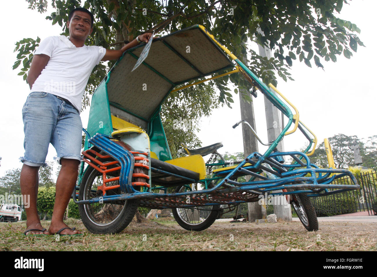 Carlo Ticar, 38, a Filipino pedicab driver wait for tourists along ...