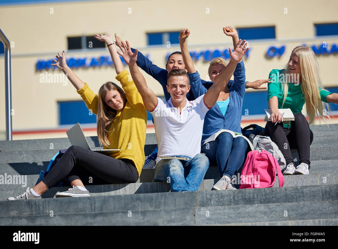 students outside sitting on steps Stock Photo - Alamy