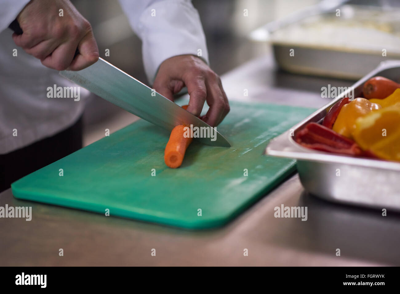 chef in hotel kitchen slice vegetables with knife Stock Photo - Alamy