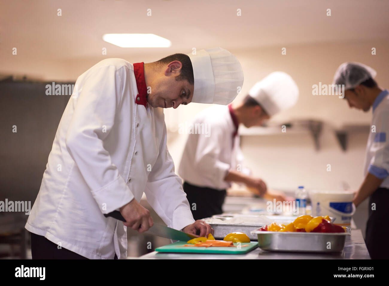 chef in hotel kitchen preparing and decorating food Stock Photo - Alamy
