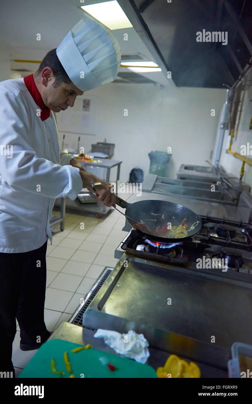 chef in hotel kitchen prepare food with fire Stock Photo - Alamy