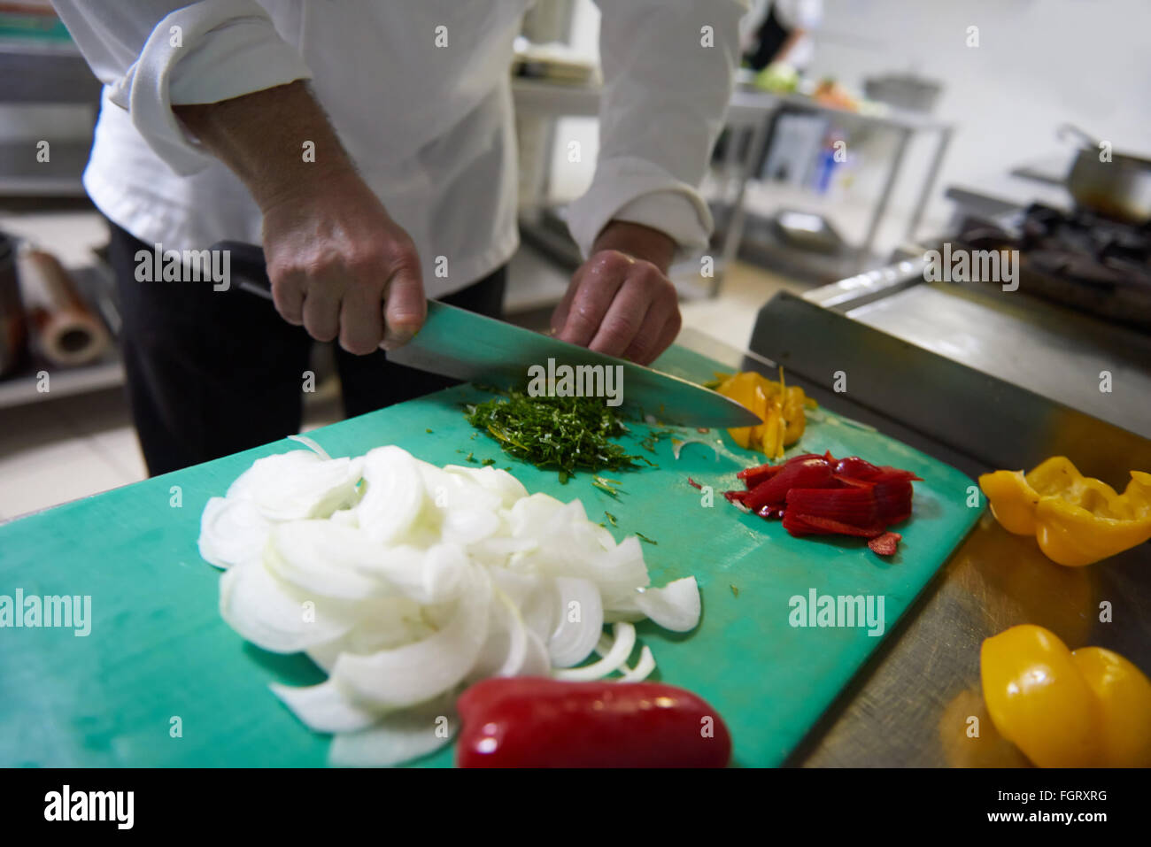 chef in hotel kitchen slice vegetables with knife Stock Photo - Alamy