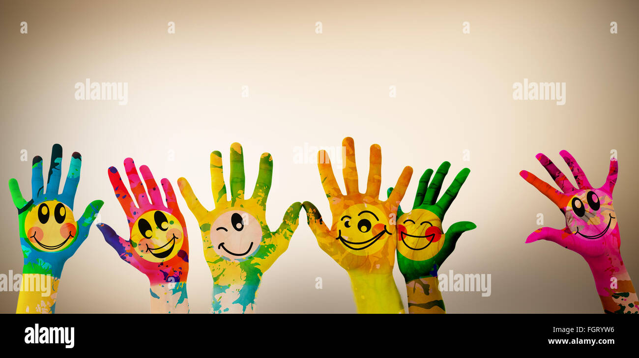 Composite image of hands with colourful smiley faces Stock Photo - Alamy