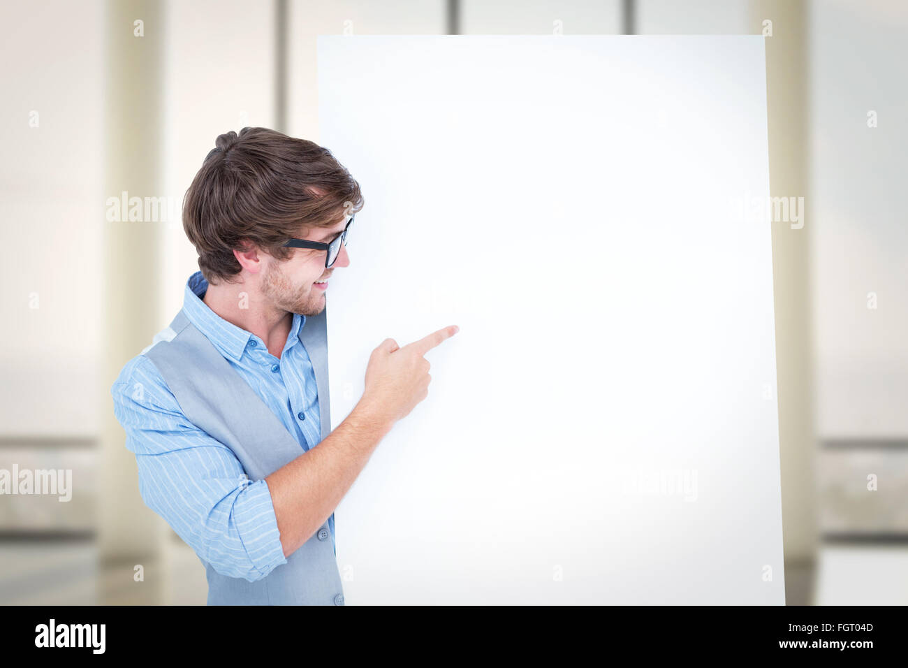 Composite image of smiling handsome man pointing at billboard Stock ...