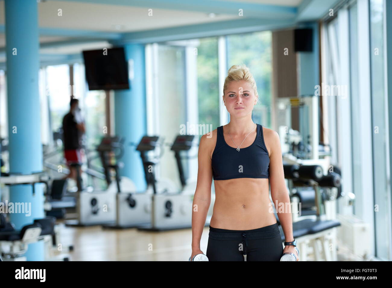 lifting some weights and working on her biceps in a gym Stock Photo - Alamy