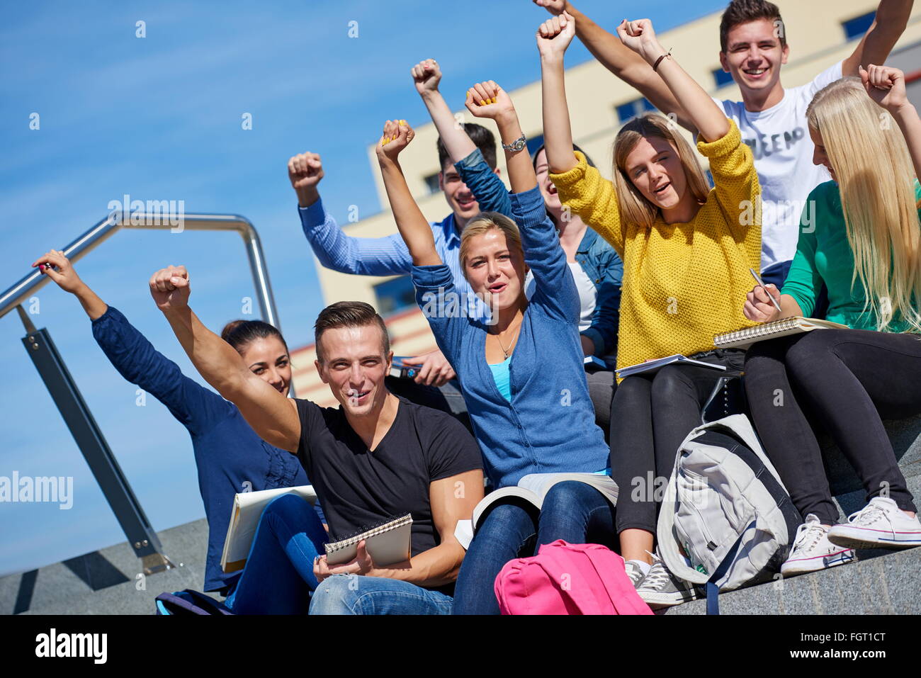 students outside sitting on steps Stock Photo - Alamy