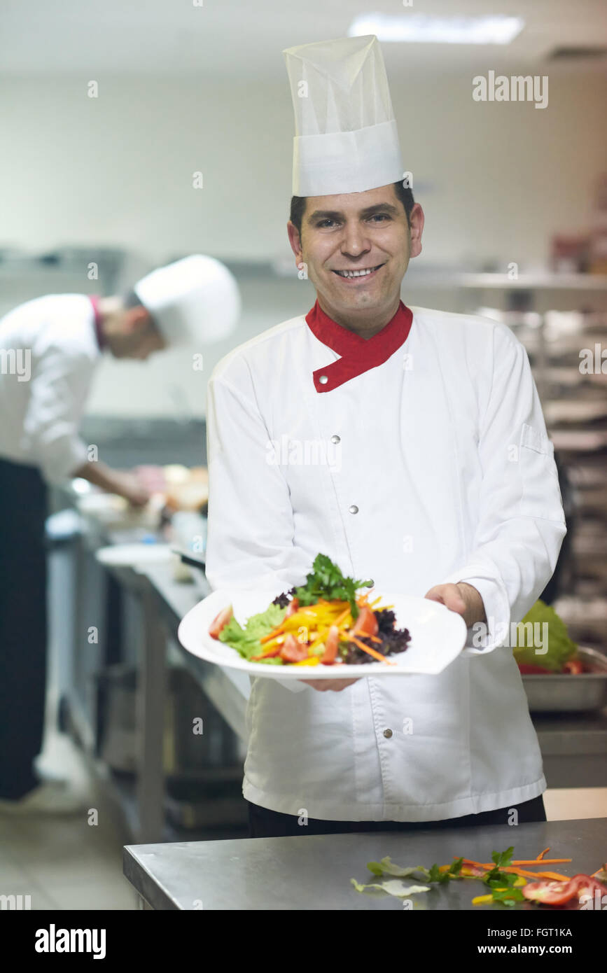 chef in hotel kitchen preparing and decorating food Stock Photo - Alamy