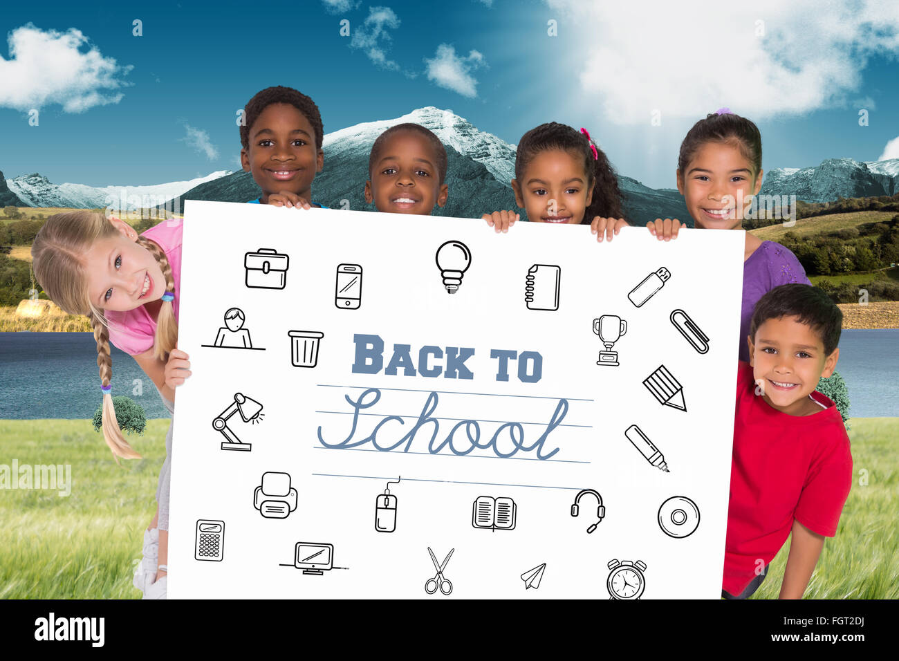Composite image of elementary pupils showing card Stock Photo - Alamy