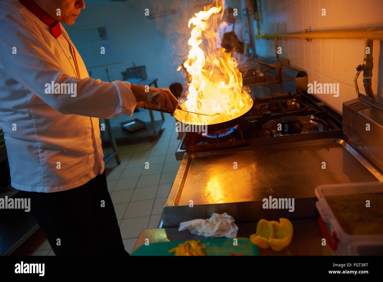 chef in hotel kitchen prepare food with fire Stock Photo - Alamy