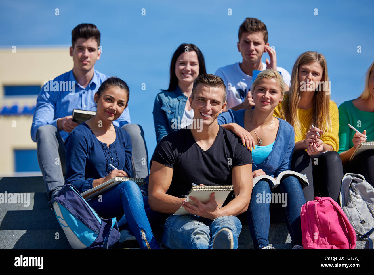 students outside sitting on steps Stock Photo - Alamy