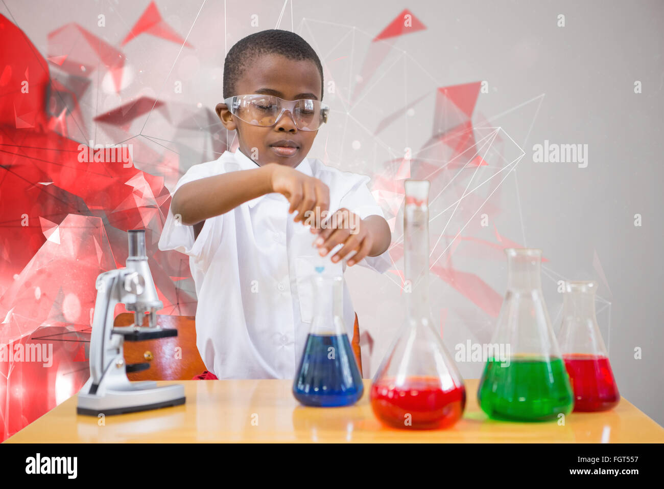 Composite image of cute pupil playing scientist Stock Photo - Alamy