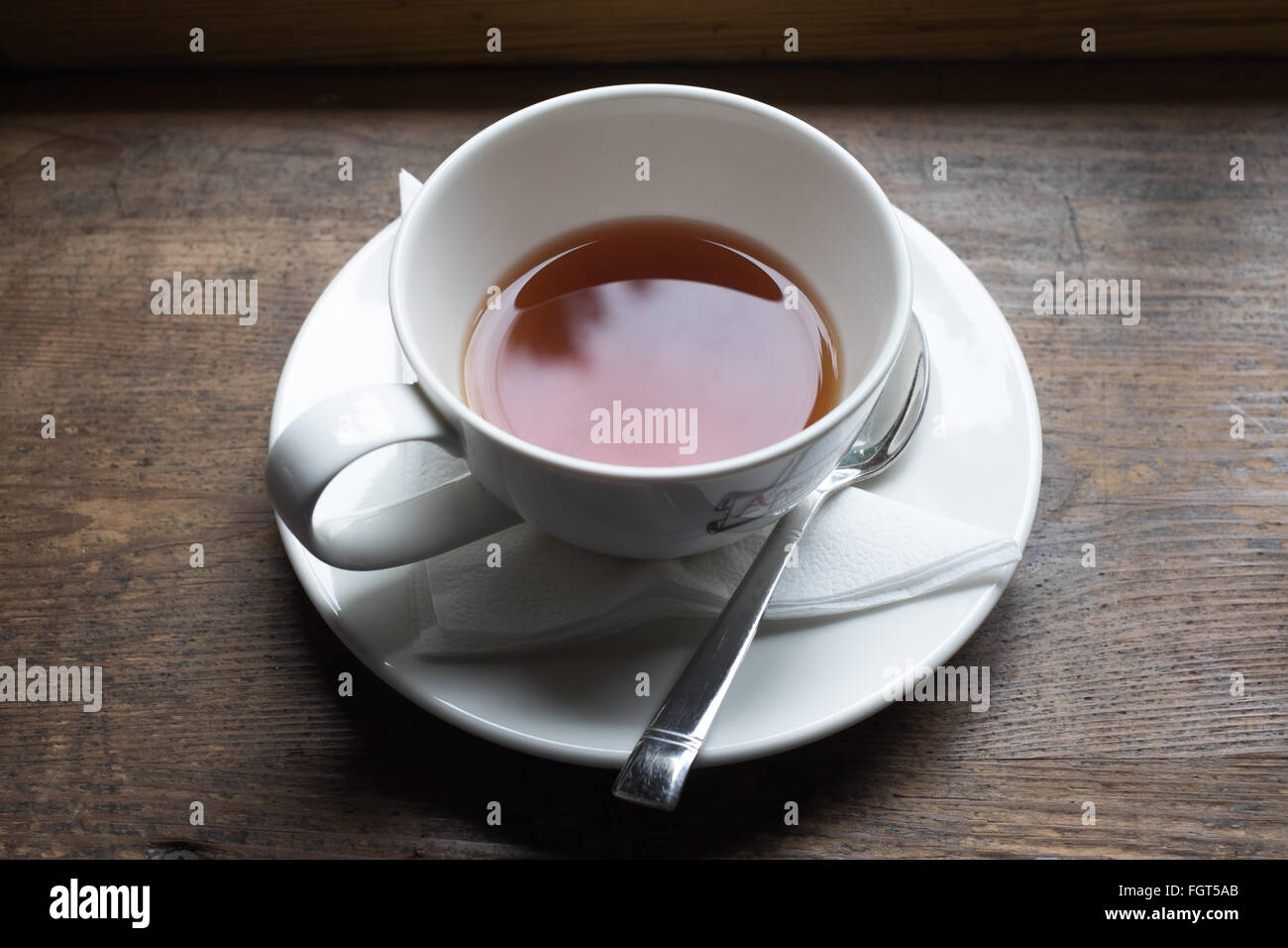 Tea cup and tea from upside on wood table Stock Photo - Alamy