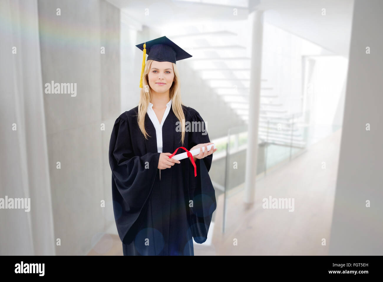 Composite image of blonde student in graduate robe holding up her ...